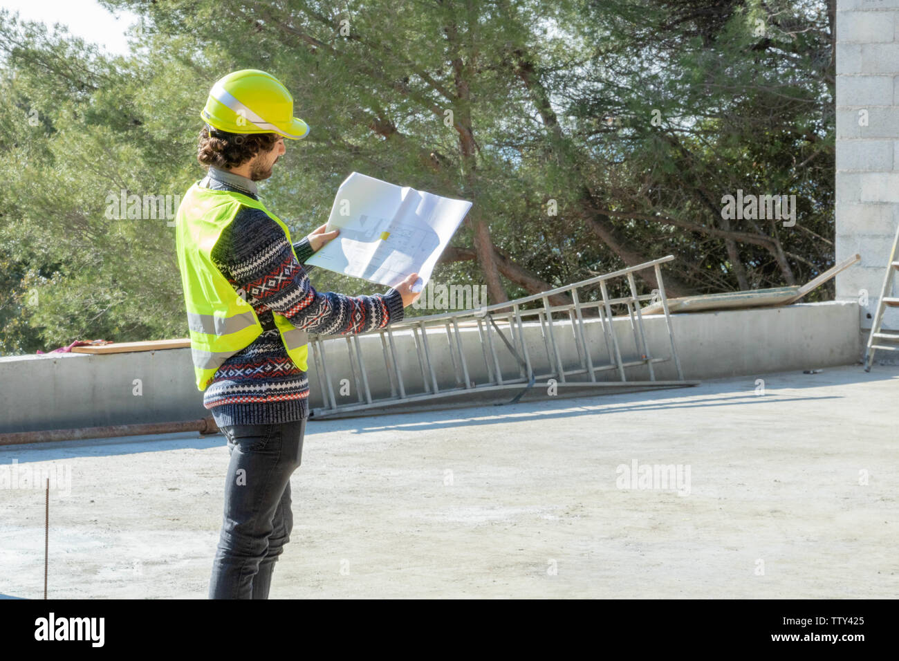 Construction site visit, architect checking the plan on the ...