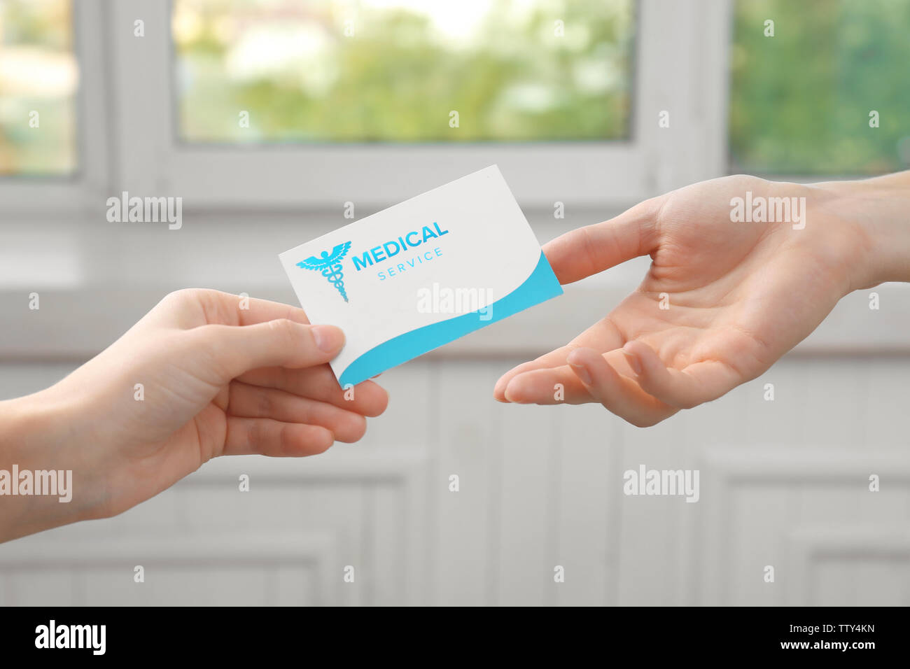 Doctor giving business card to patient, closeup Stock Photo - Alamy