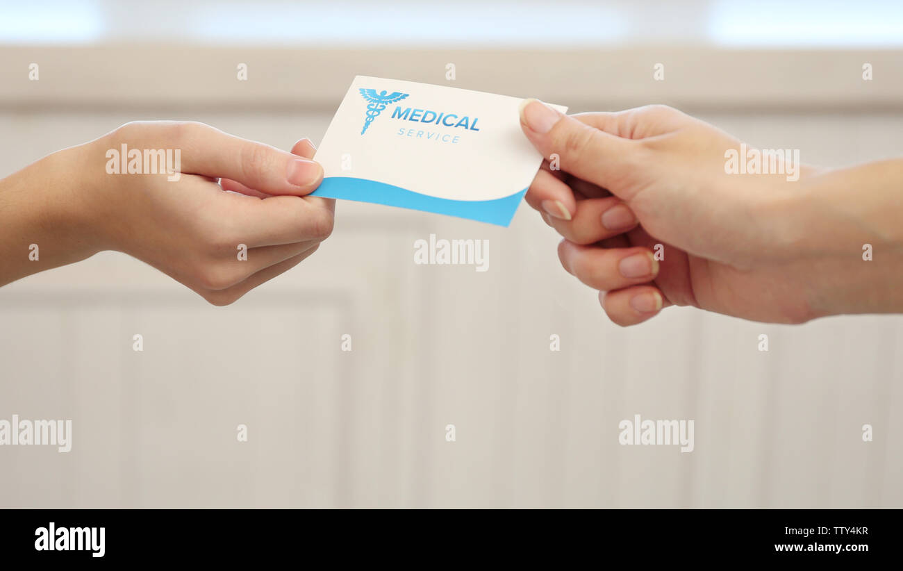Doctor giving business card to patient, closeup Stock Photo - Alamy