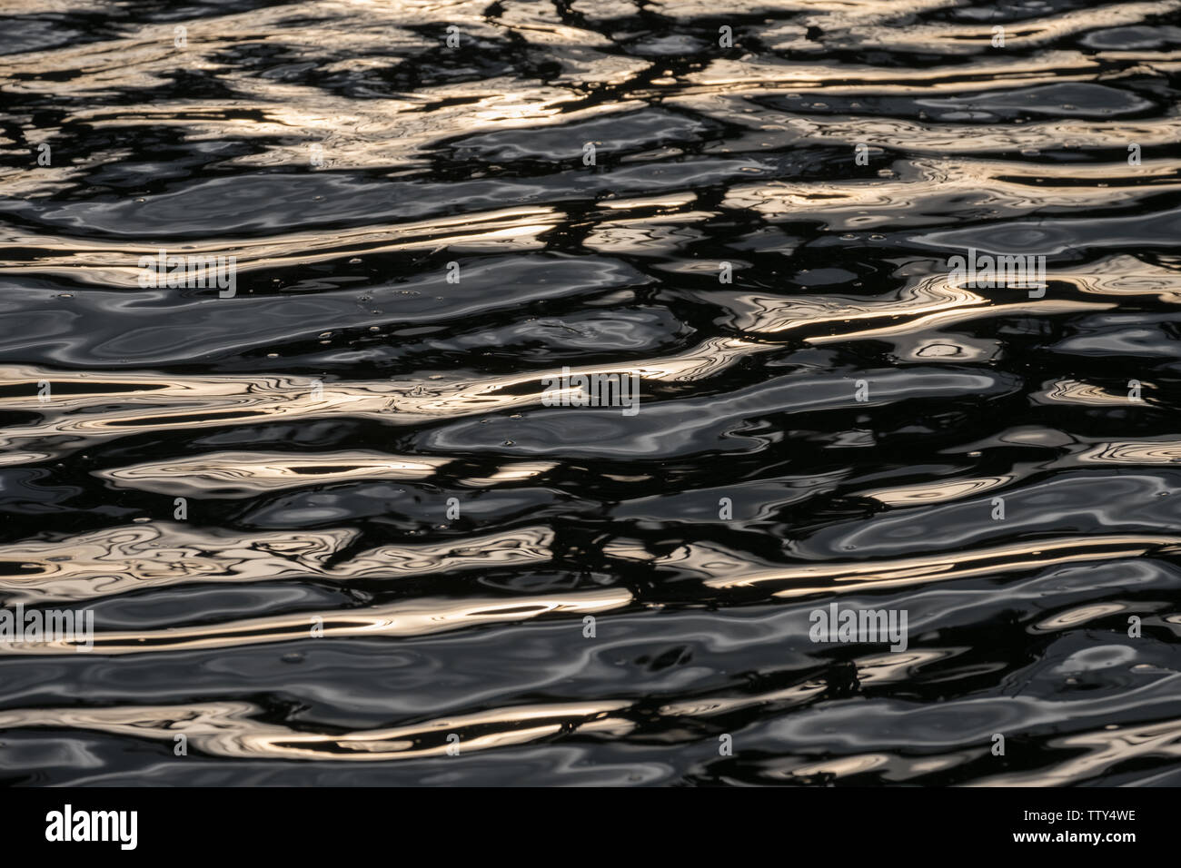 Water surface river ripple with reflection and golden shining Stock ...