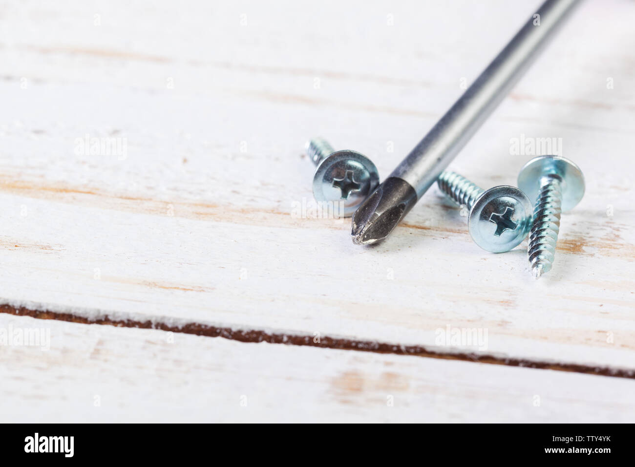 screw screwed into a wooden bar Stock Photo - Alamy