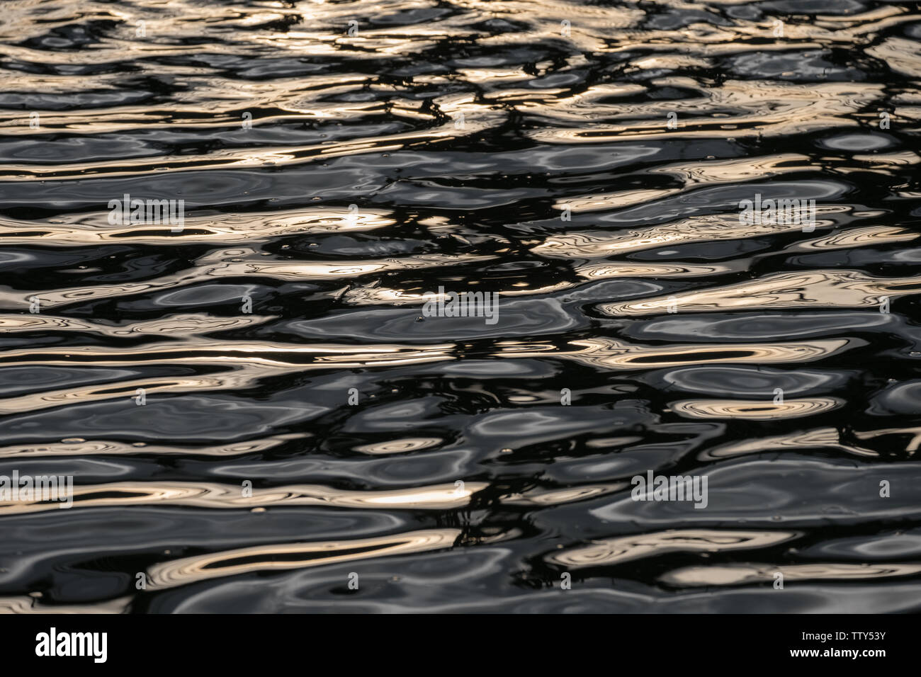 Water surface river ripple with reflection and golden shining Stock ...