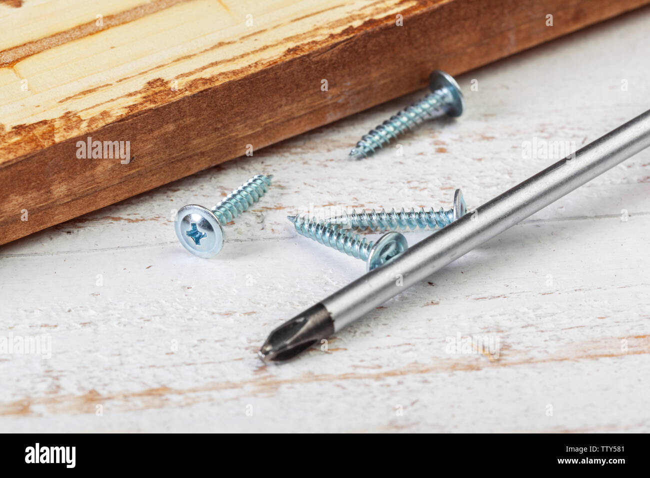 screw screwed into a wooden bar Stock Photo - Alamy