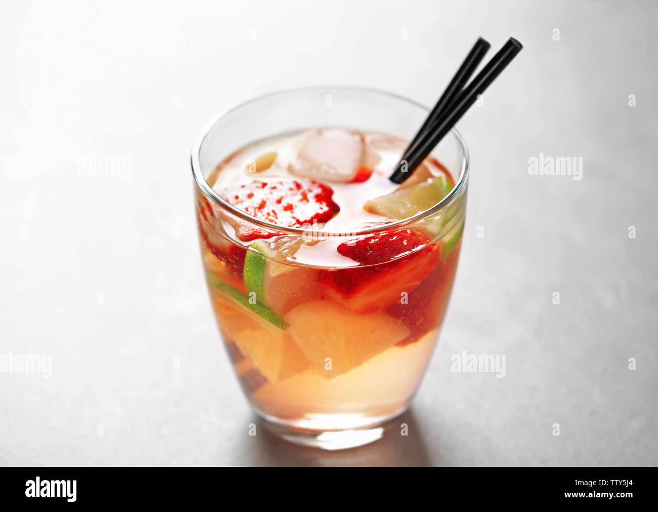 Glass of cold fruit cocktail on light background Stock Photo - Alamy