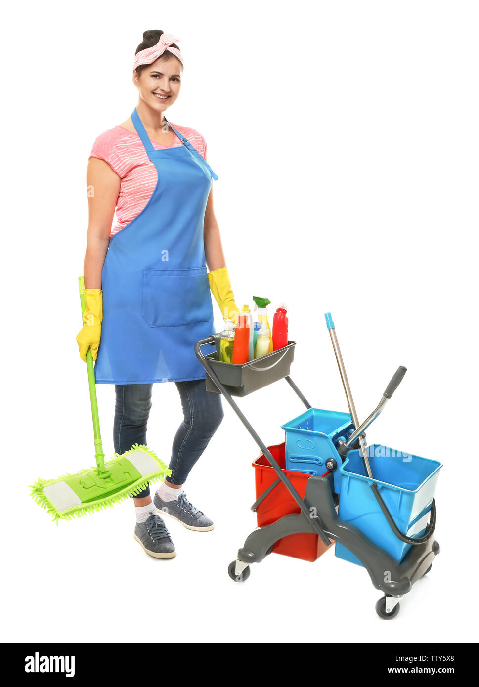 Young cleaner with cart and cleaning supplies on white background Stock ...