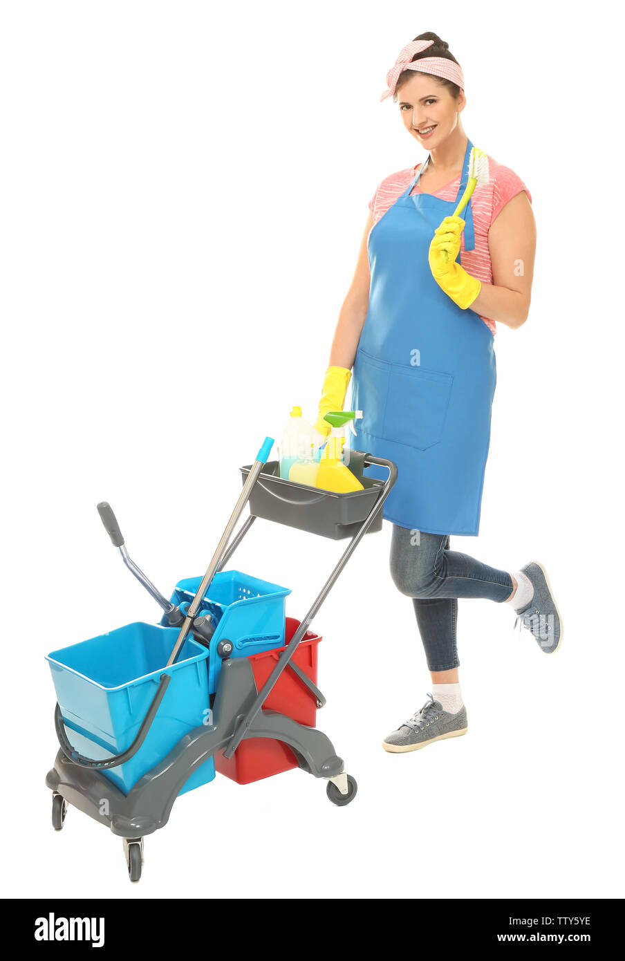 Young cleaner with cart and cleaning supplies on white background Stock ...