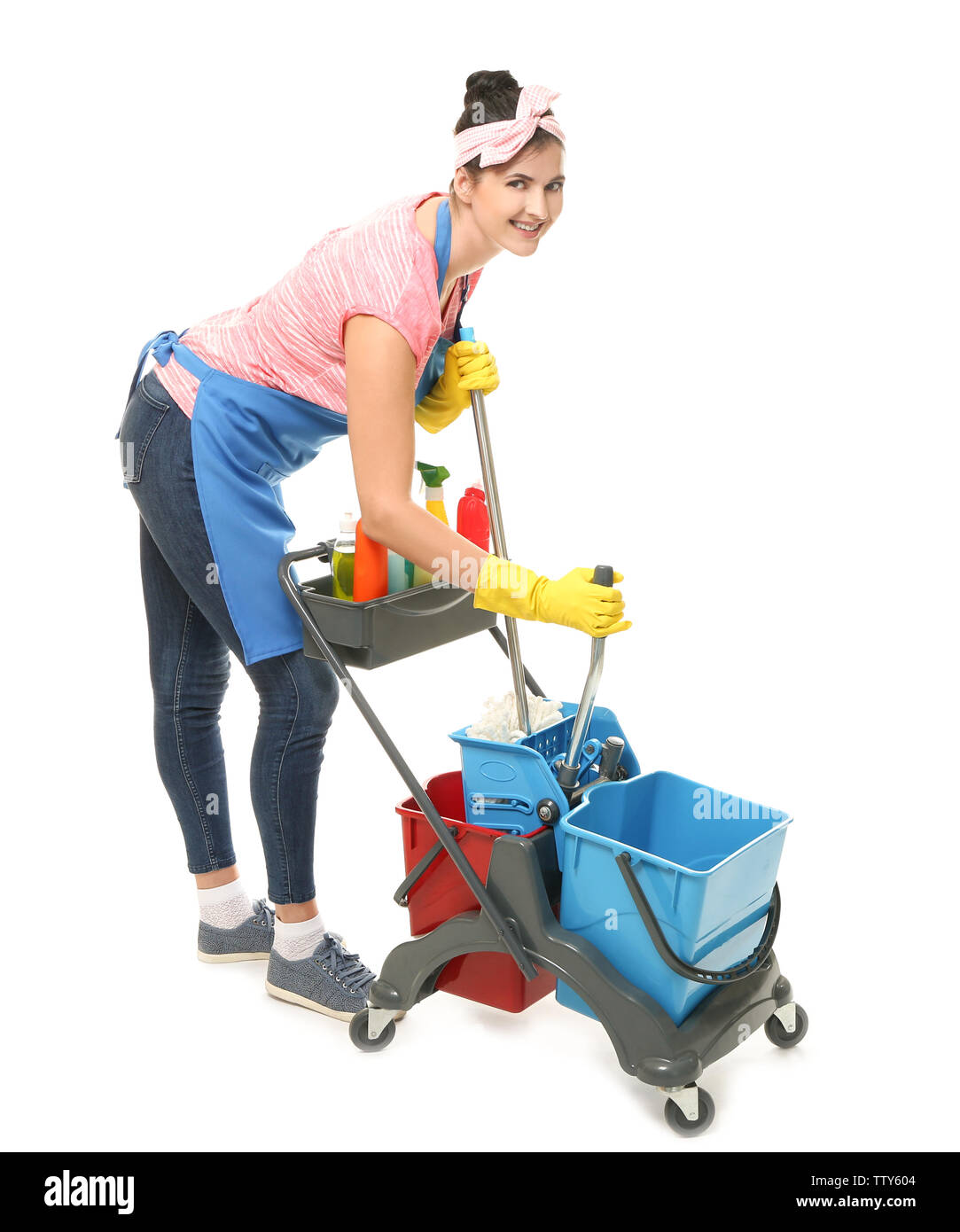 Young cleaner with cart and cleaning supplies on white background Stock ...
