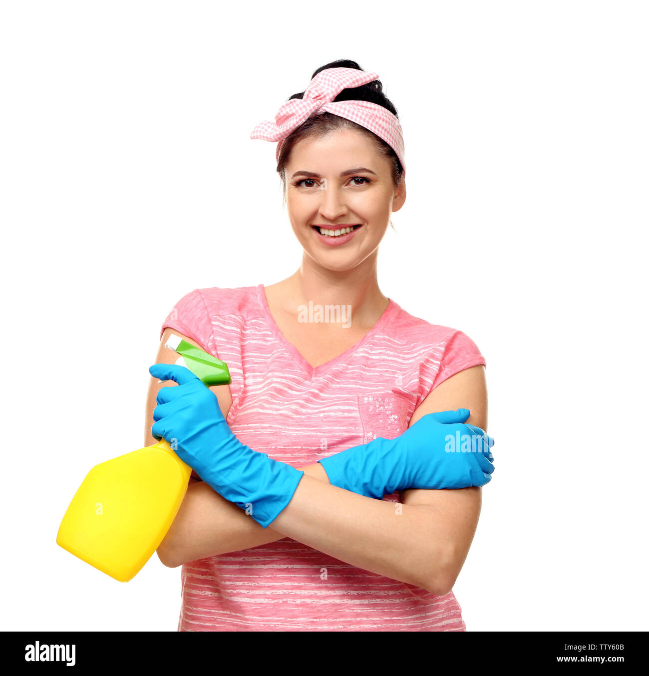 Young cleaner with spray on white background Stock Photo - Alamy