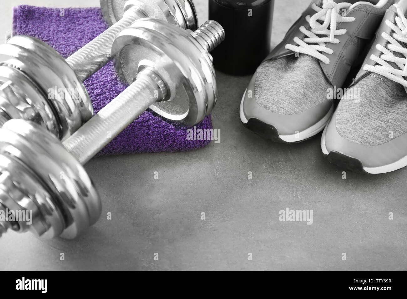 Sports concept. Workout objects on grey background Stock Photo - Alamy