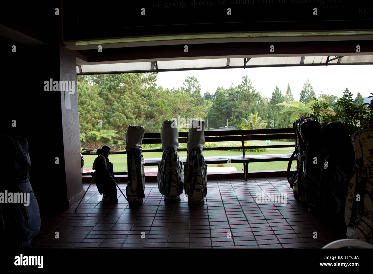 Golf bags at driving range Stock Photo - Alamy
