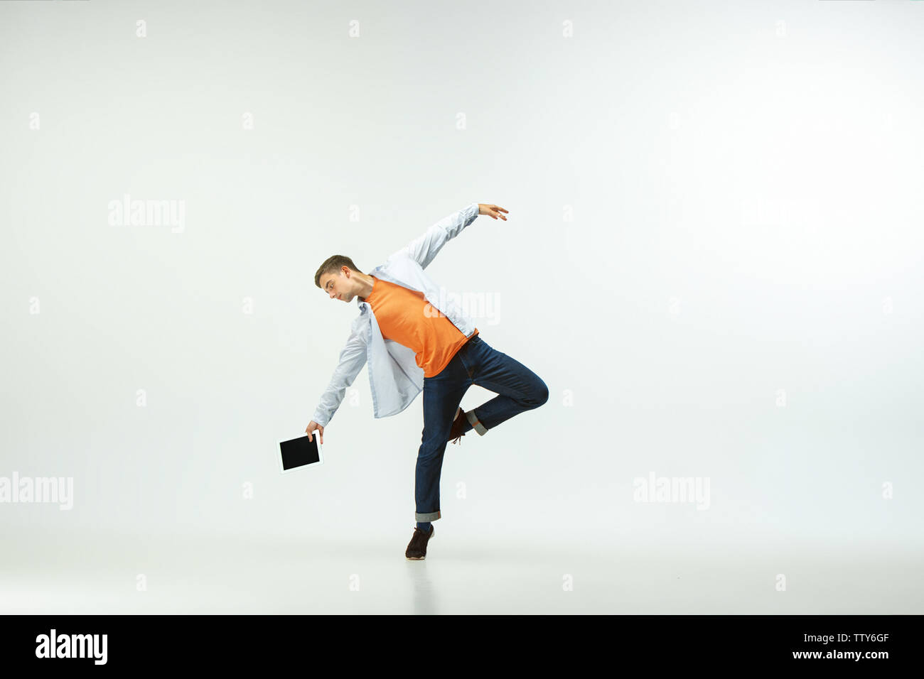 Happy young man working at office, jumping and dancing in casual ...