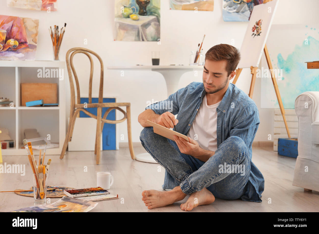 Young male artist drawing sketch in studio Stock Photo - Alamy