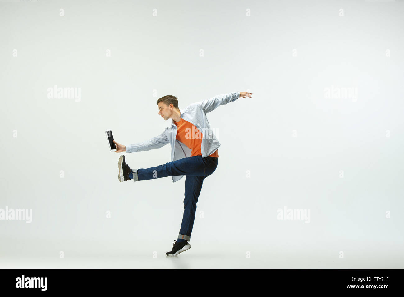 Happy young man working at office, jumping and dancing in casual ...
