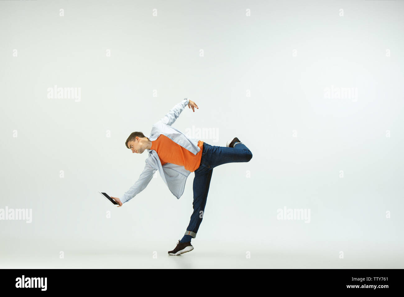 Happy young man working at office, jumping and dancing in casual ...