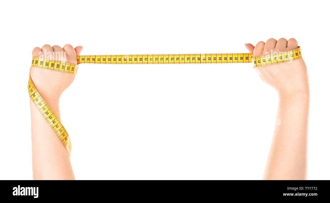 Female hands holding measuring tape on white background Stock Photo - Alamy