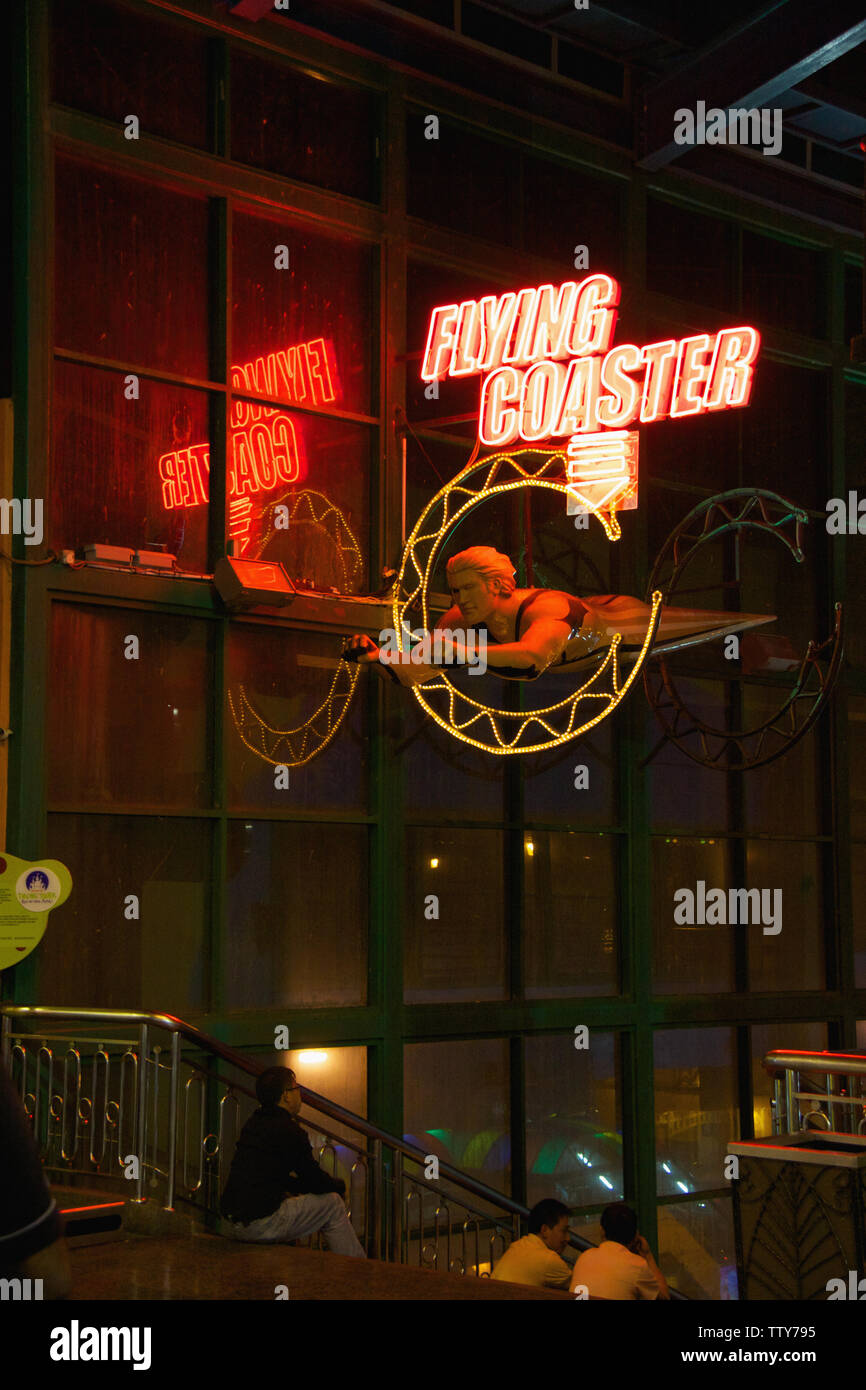 Glowing flying coaster sign in an amusement park, Genting Highlands ...