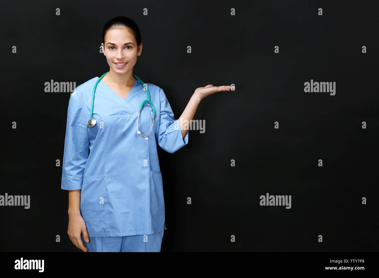 Young beautiful medical student on blackboard background Stock Photo ...