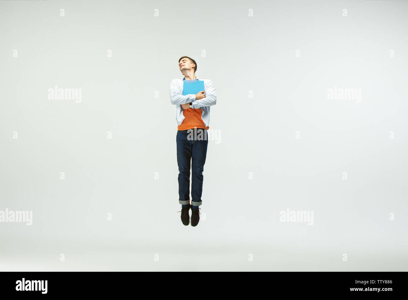 Happy young man working at office, jumping and dancing in casual ...