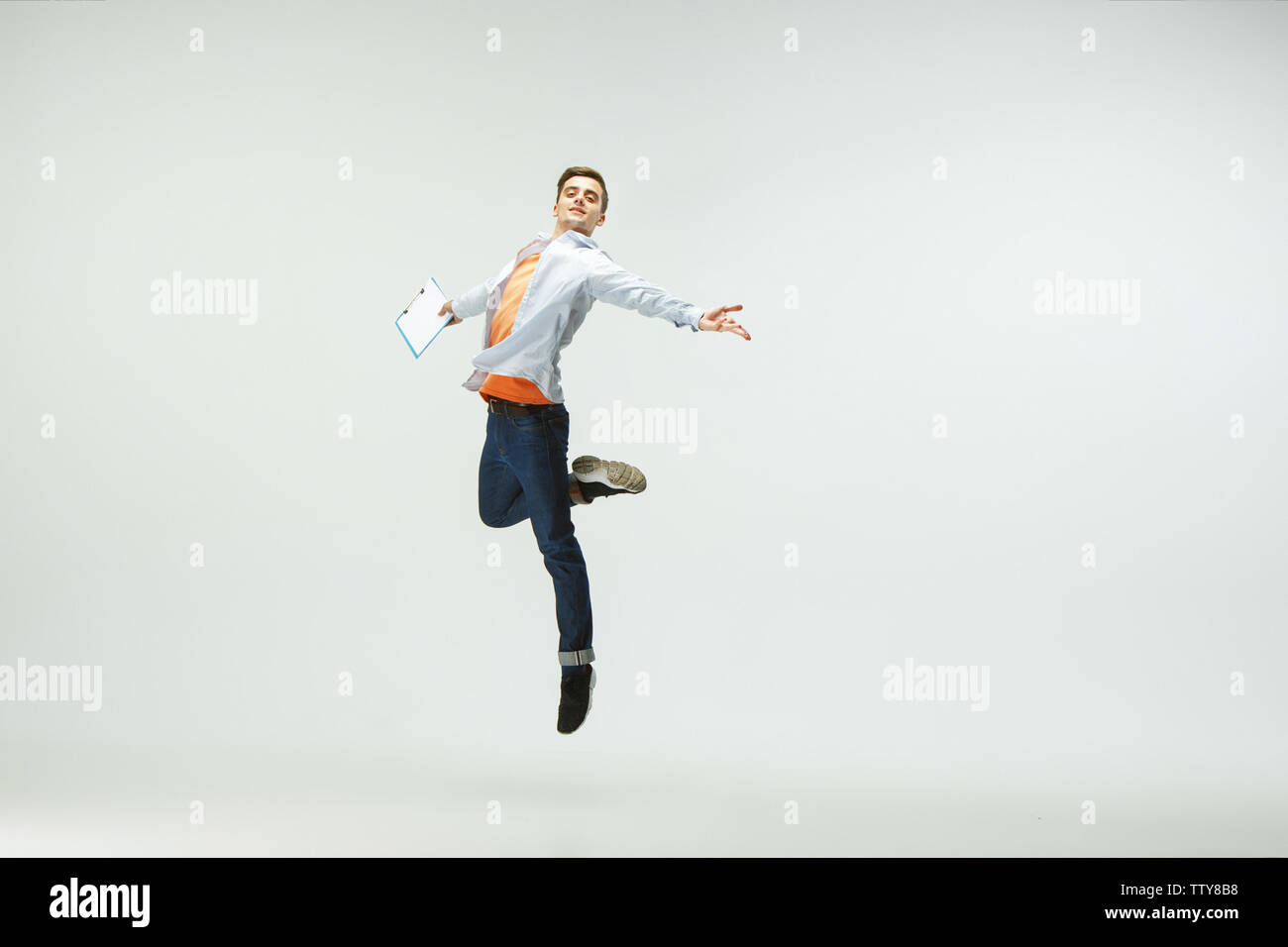Happy young man working at office, jumping and dancing in casual ...