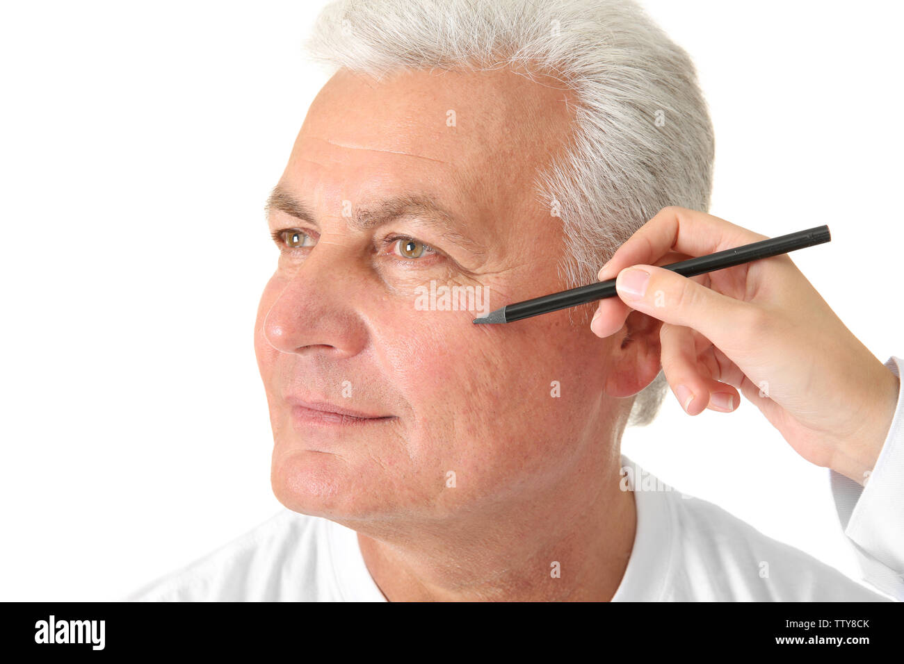Female hand drawing correction line on man's face on white background ...