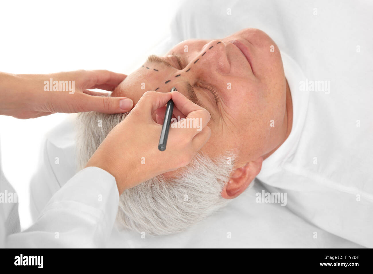 Female hand drawing correction line on man's face, close up Stock Photo ...
