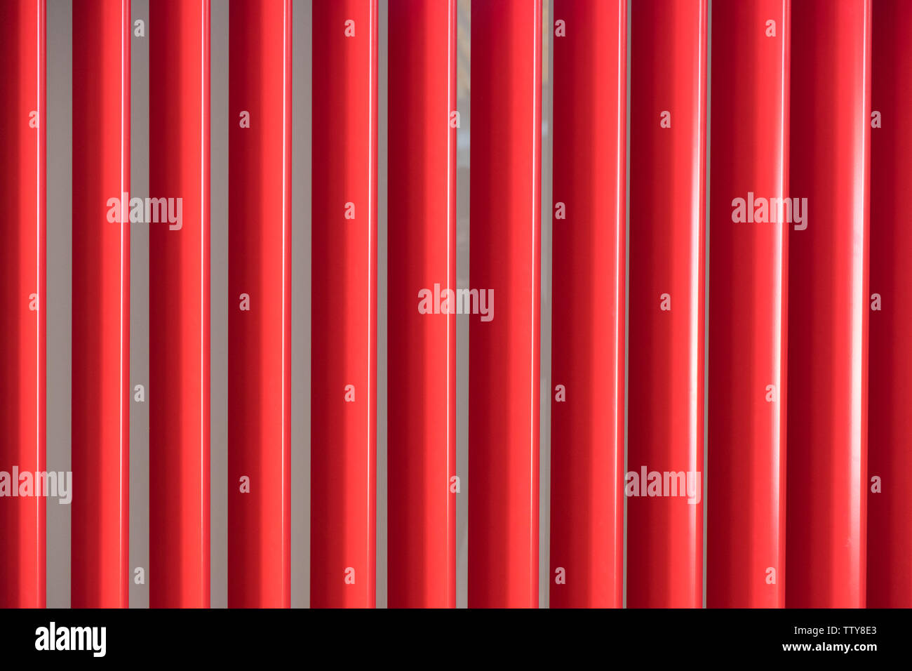 Red modern fin sunshade row lined background Stock Photo - Alamy