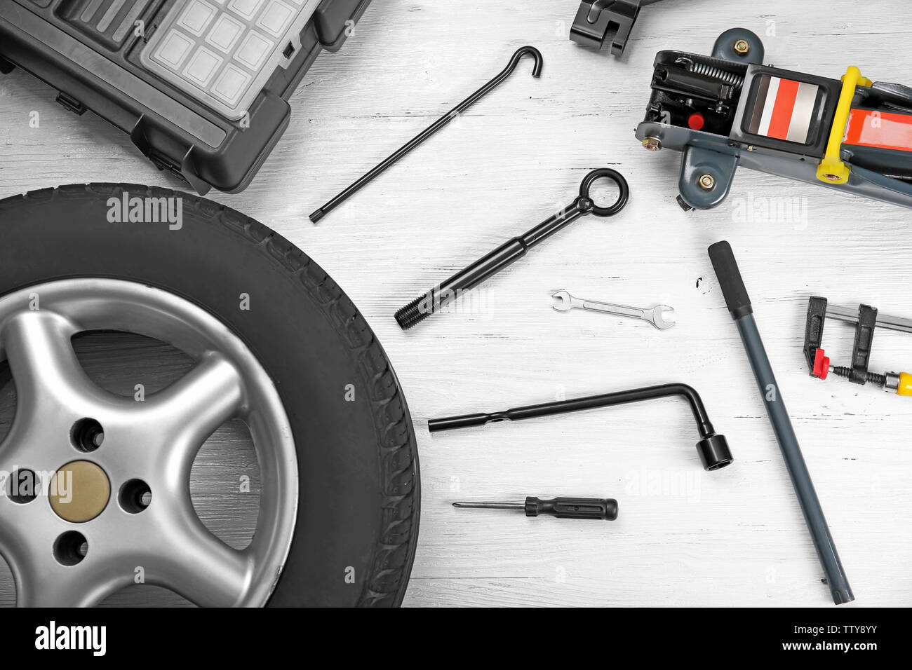 Car wheel with tools on wooden background Stock Photo - Alamy