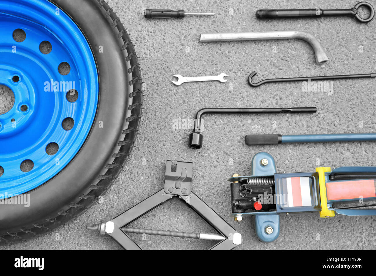 Car wheel with tools on asphalt background Stock Photo - Alamy