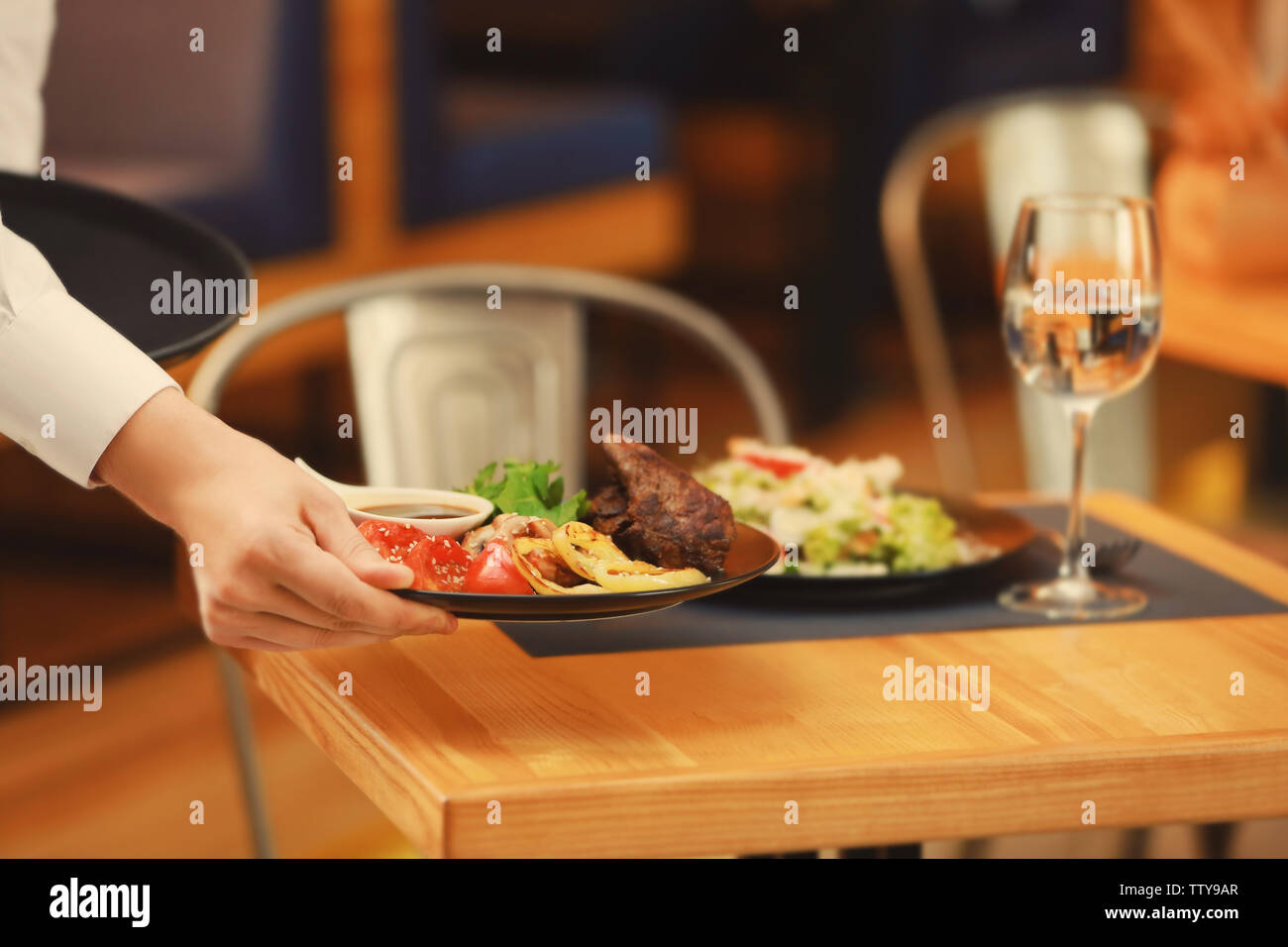 Waiter serving water in restaurant hi-res stock photography and images ...