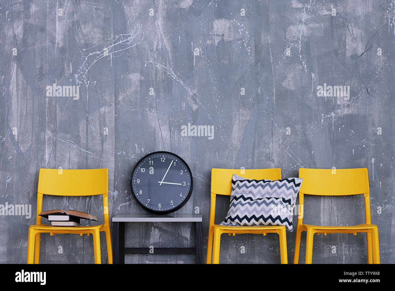 Modern chairs on wall background Stock Photo - Alamy