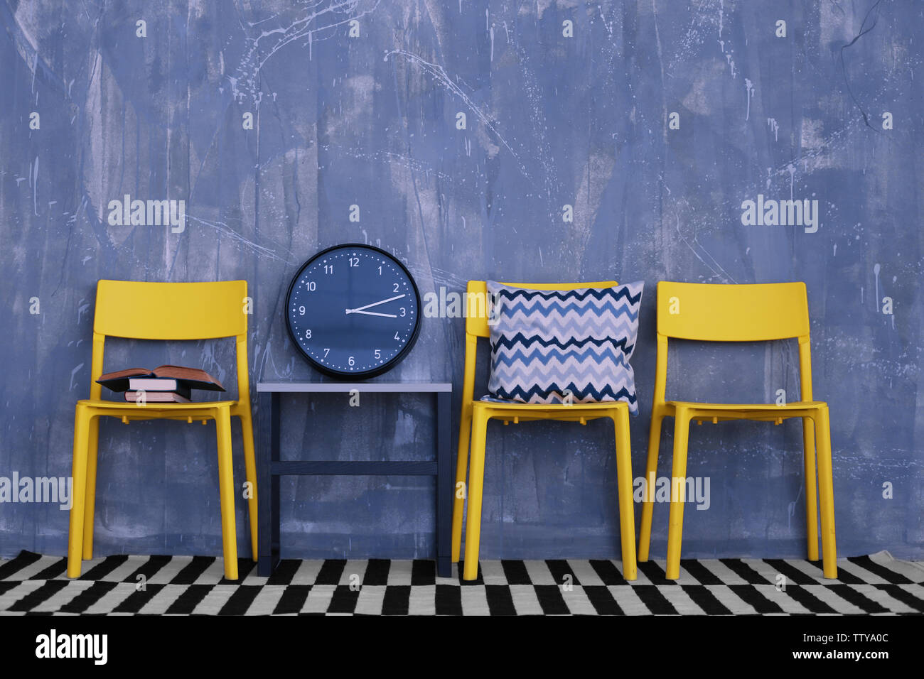 Modern chairs on wall background Stock Photo - Alamy