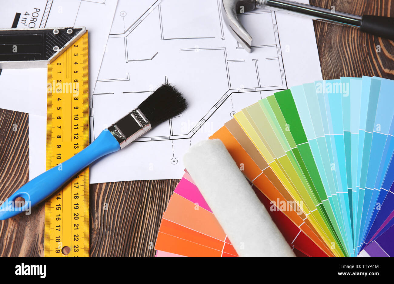 Decorator workplace with house project, color swatches and tools ...