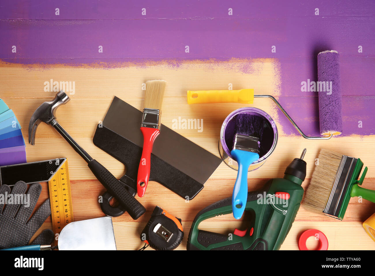 House renovation tools on purple painted wooden background Stock Photo ...