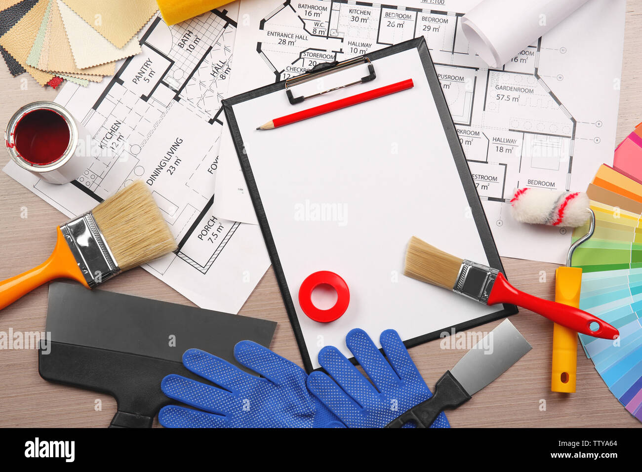 Clipboard and decorator tools on house project, closeup Stock Photo - Alamy