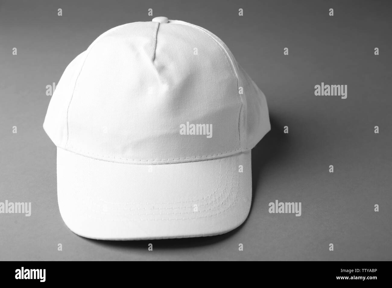 Blank white baseball cap on grey background Stock Photo - Alamy