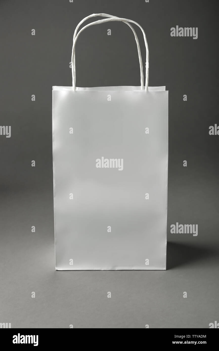 Blank paper bag on grey background Stock Photo - Alamy