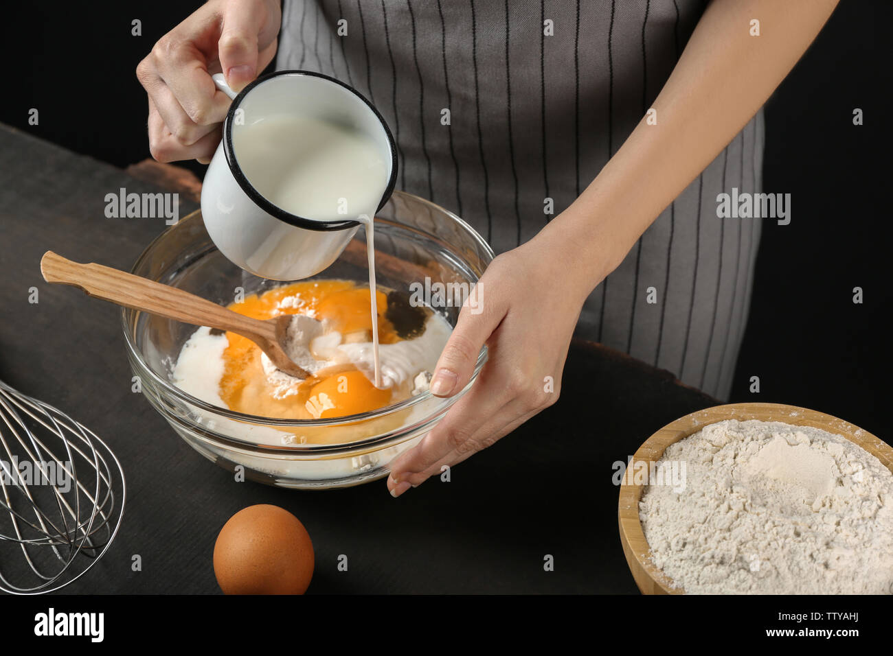 Woman preparing dough pouring milk hi-res stock photography and images ...