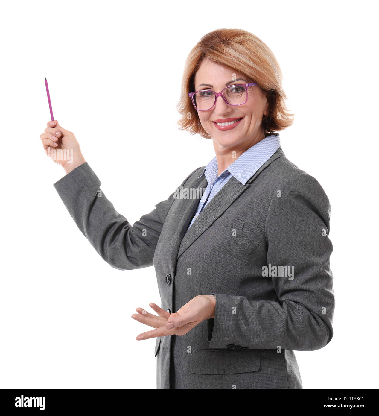 Middle-aged teacher pointing at something isolated on white Stock Photo ...