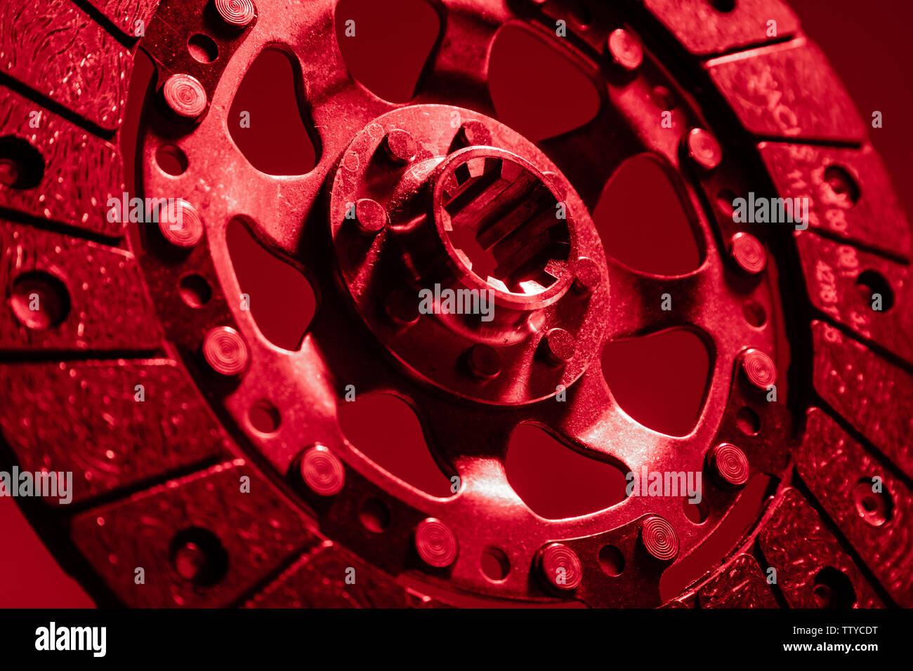 Shot of modern new spare parts for car in red artificial lighting made ...