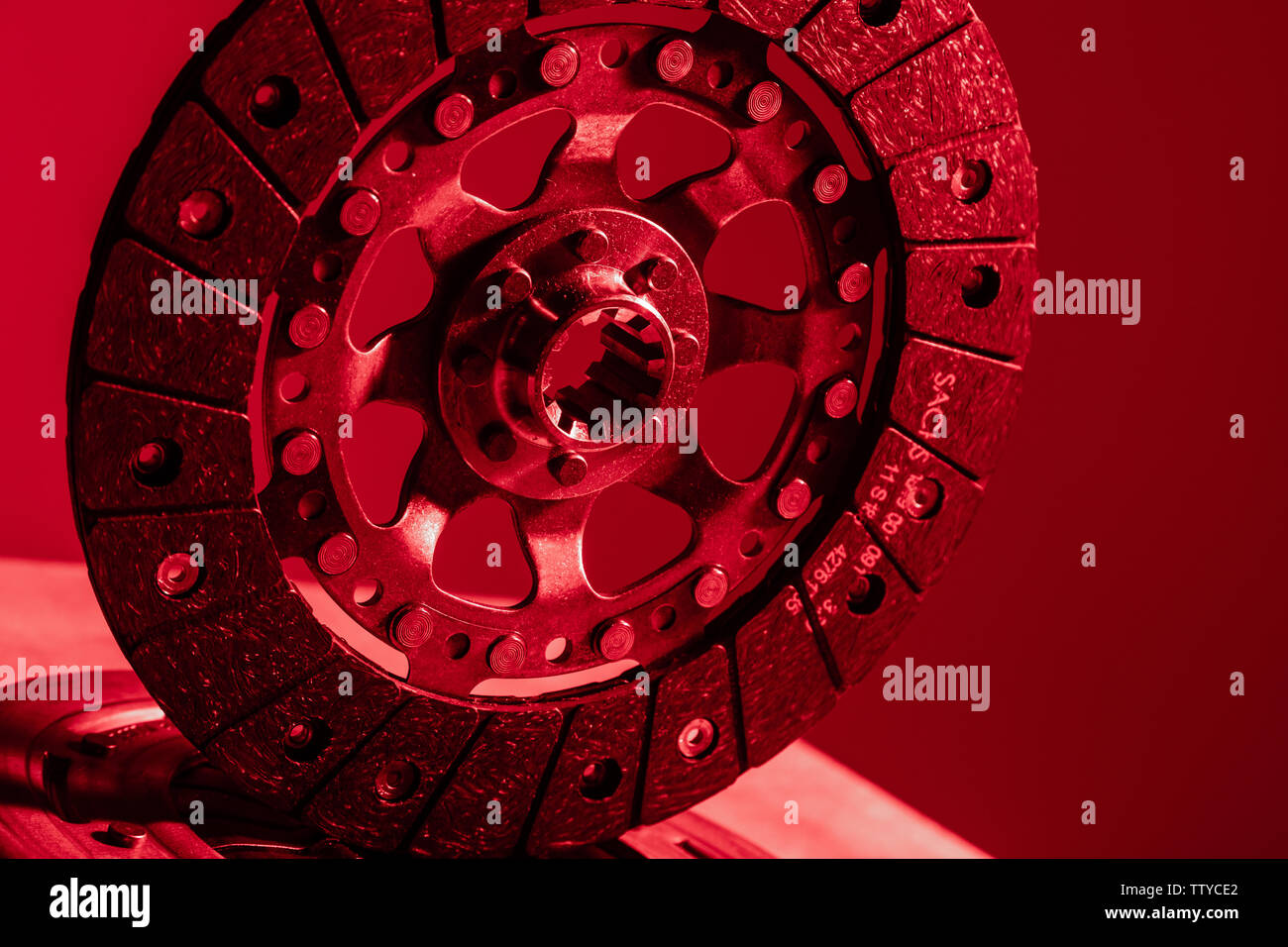 Shot of modern new spare parts for car in red artificial lighting made ...