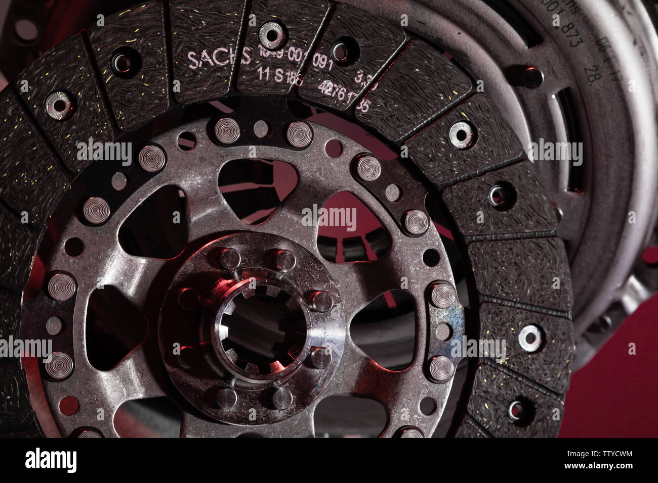 Shot of modern new spare parts for car in red artificial lighting made ...