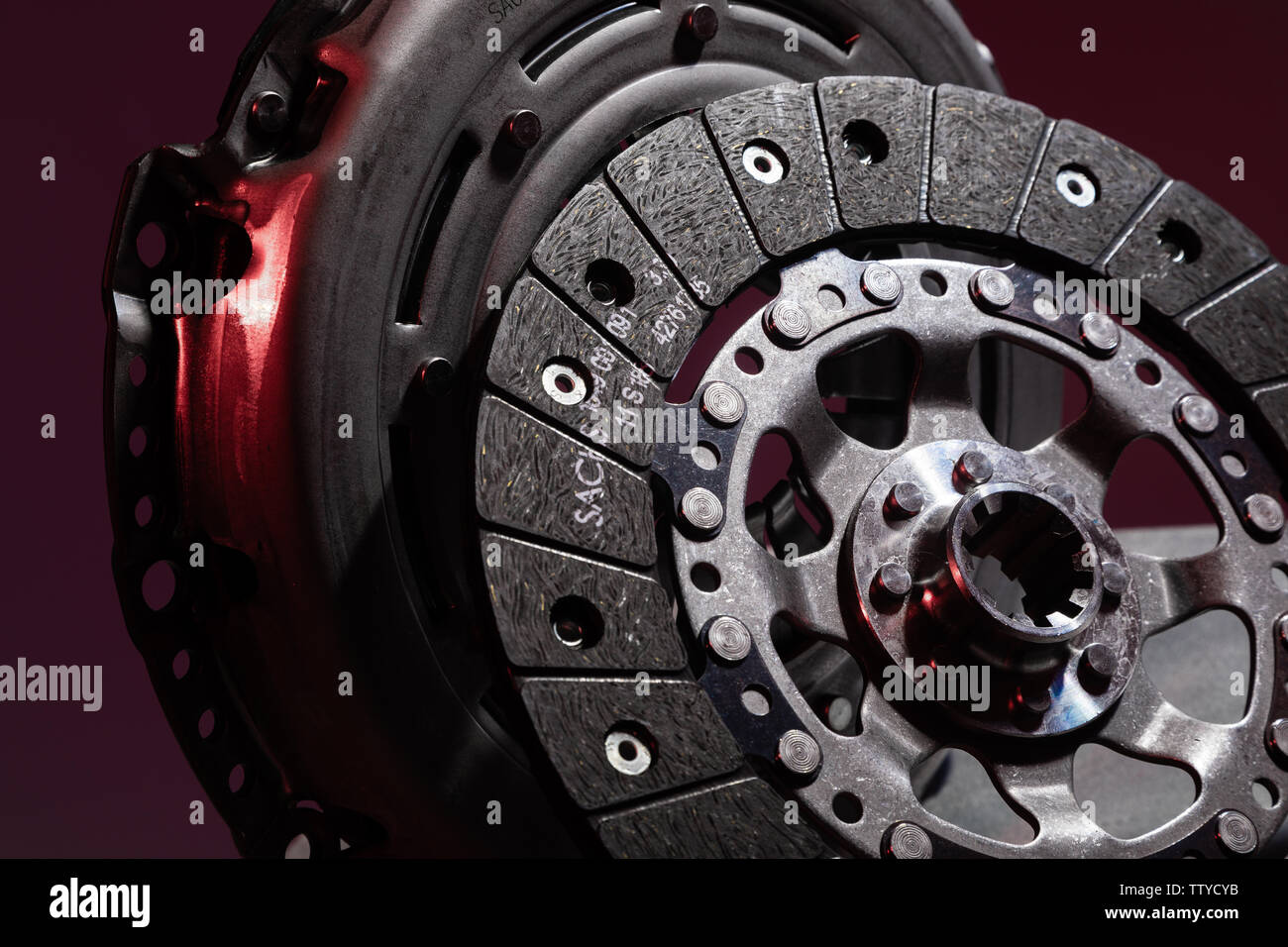 Shot of modern new spare parts for car in red artificial lighting made ...