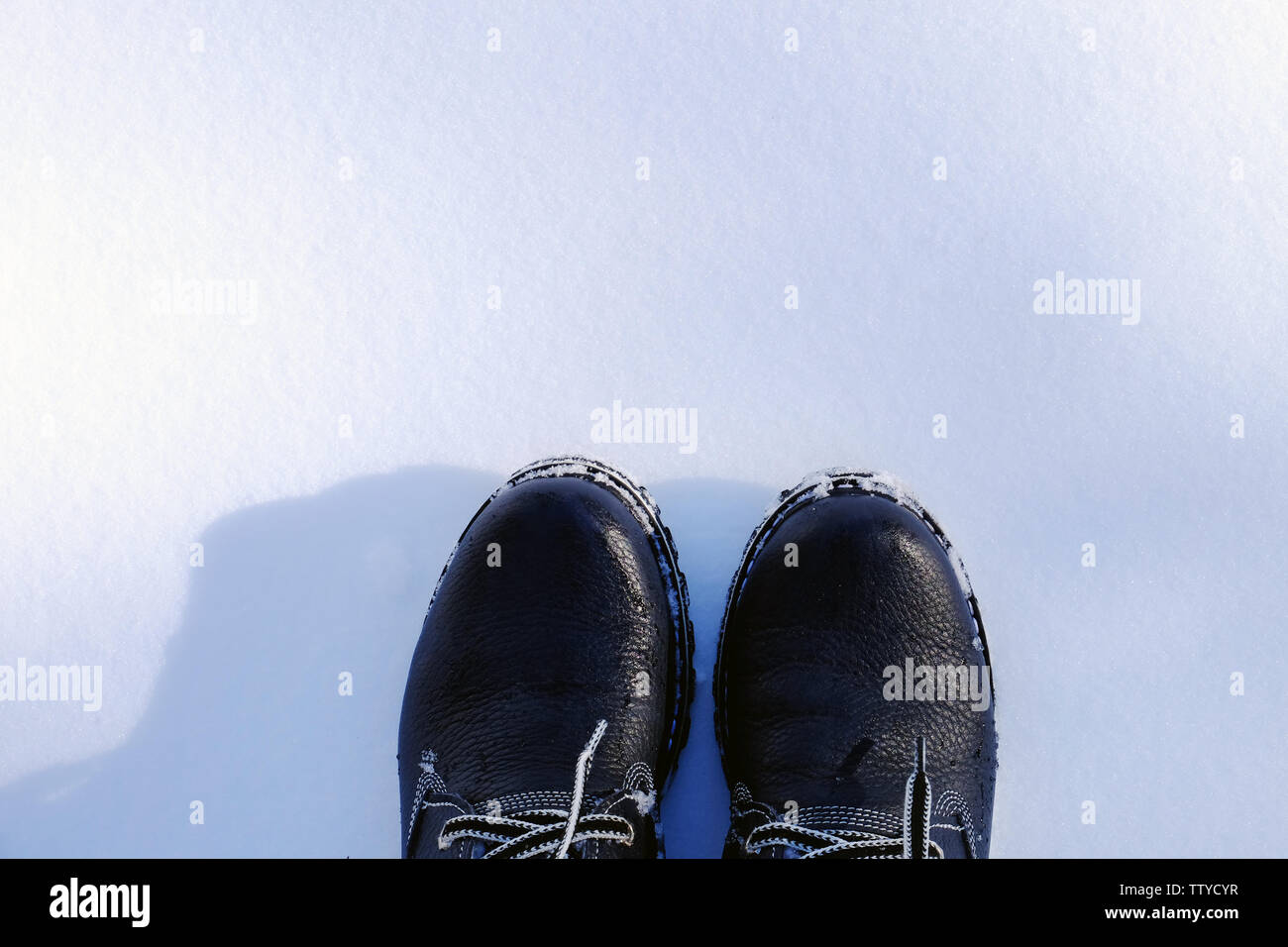 Human feet in boots on white snow Stock Photo - Alamy
