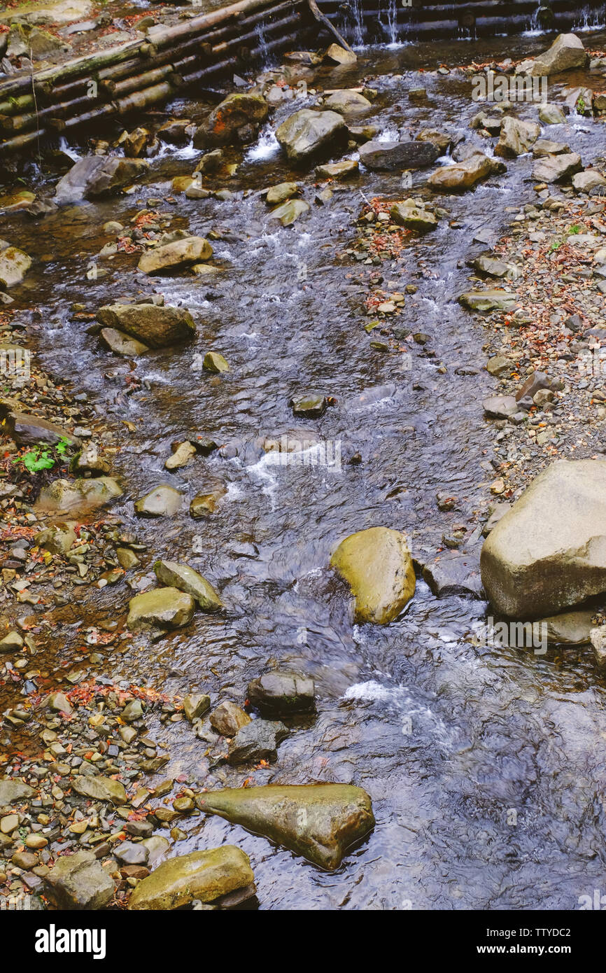Stream flowing through rocky path in mountains Stock Photo - Alamy
