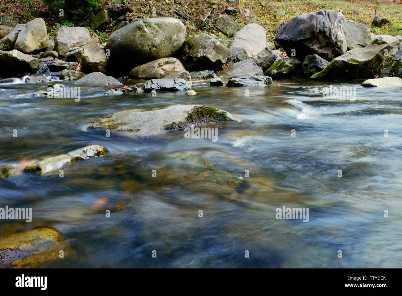 Stream flowing through rocky path in mountains Stock Photo - Alamy
