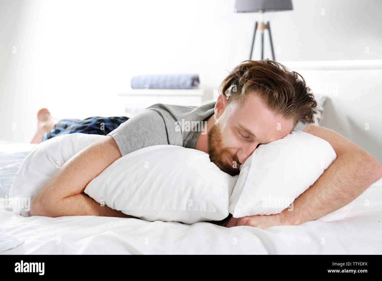 Young man sleeping in bed at home Stock Photo - Alamy