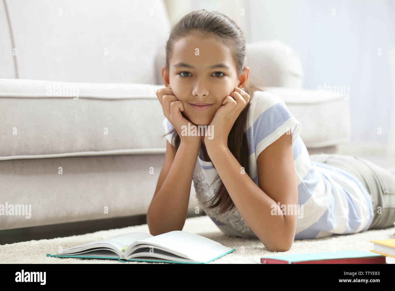 Cute girl doing lessons at home Stock Photo - Alamy