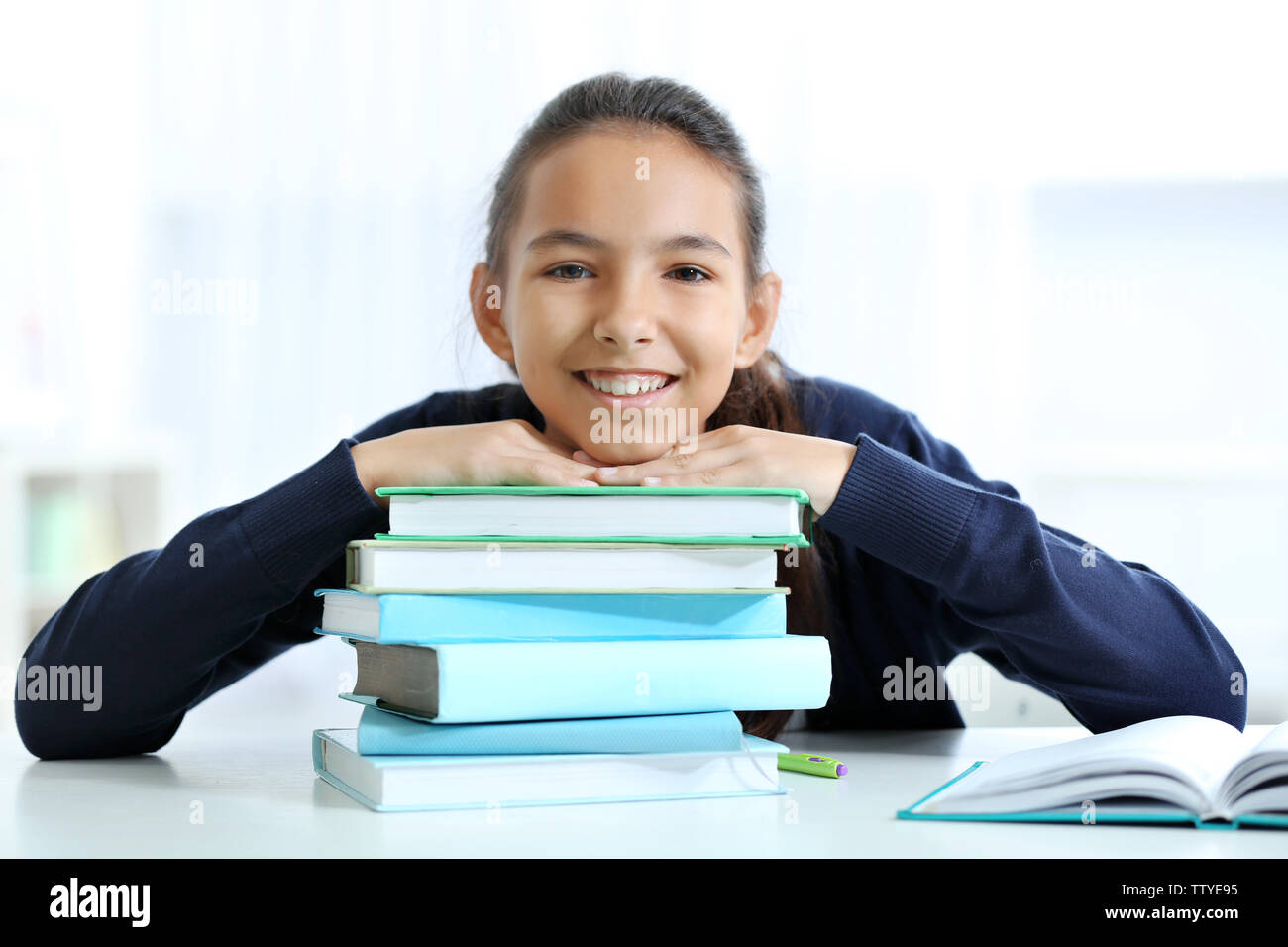Cute girl doing lessons at home Stock Photo - Alamy