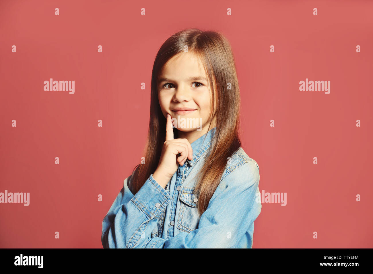 Portrait of cute little girl on color background Stock Photo - Alamy