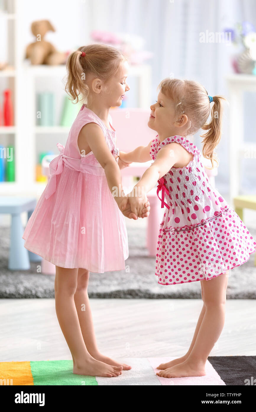 Cheerful little girls dancing at home Stock Photo - Alamy